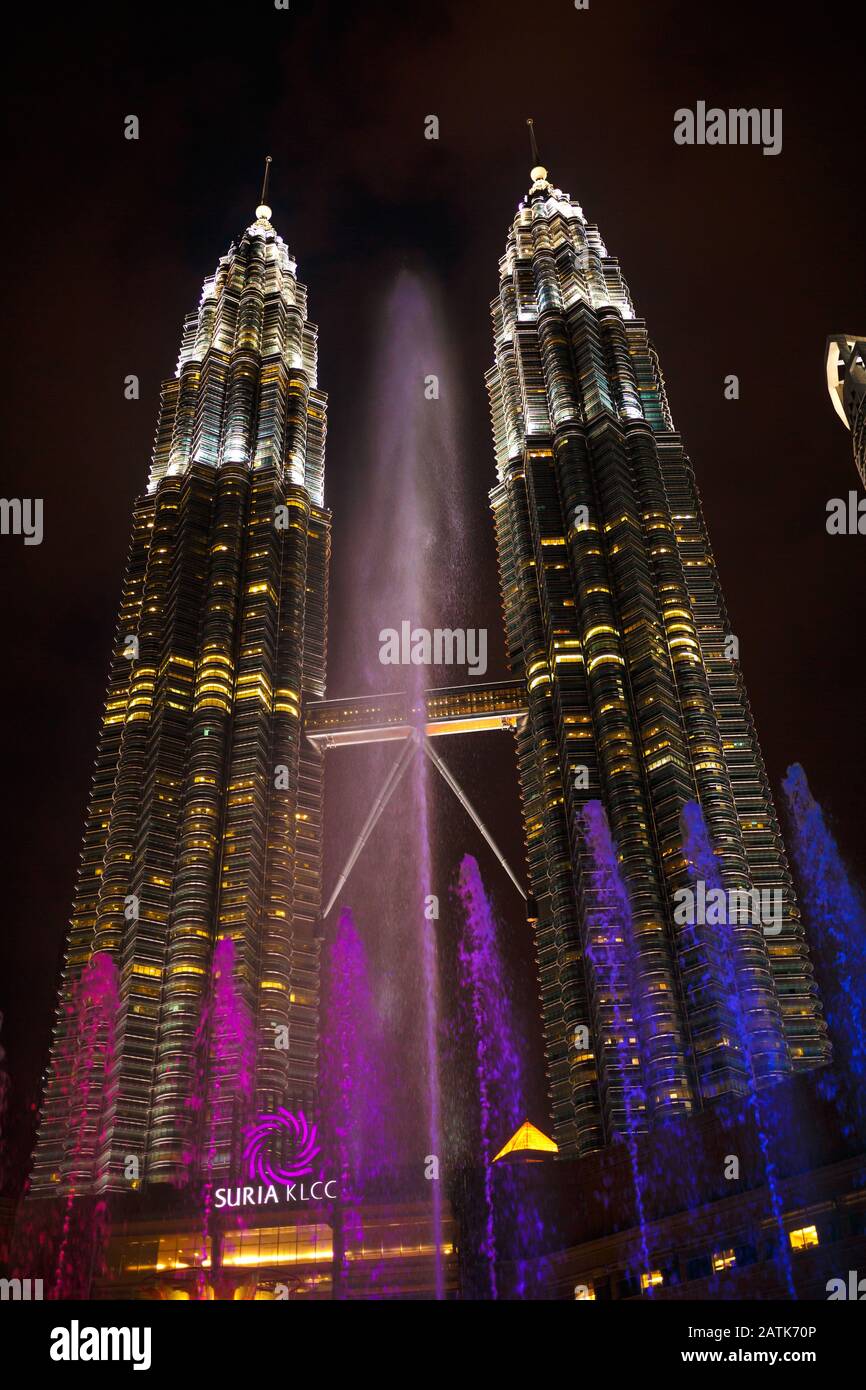 Multi-colored dancing fountains near the twin towers of Petronas in ...