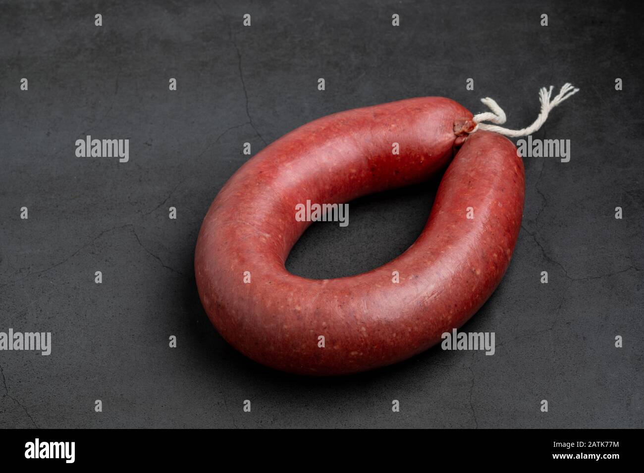 Turkish sausage kangal sausage. Dry spicy sausage on dark stone ...
