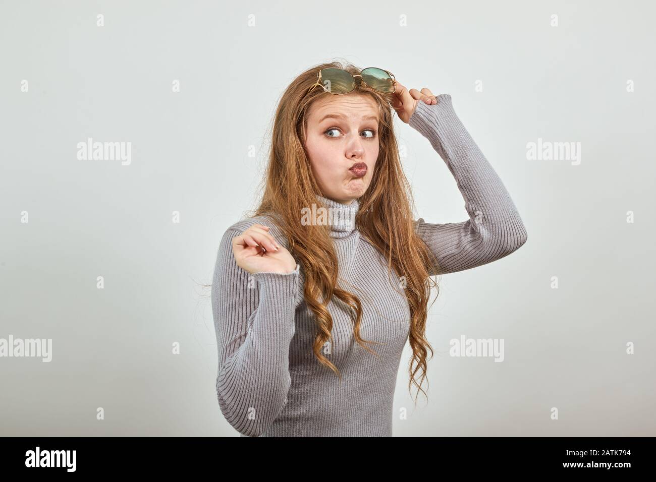 red haired woman in gray sweater with goofy smisnim expression funny ...