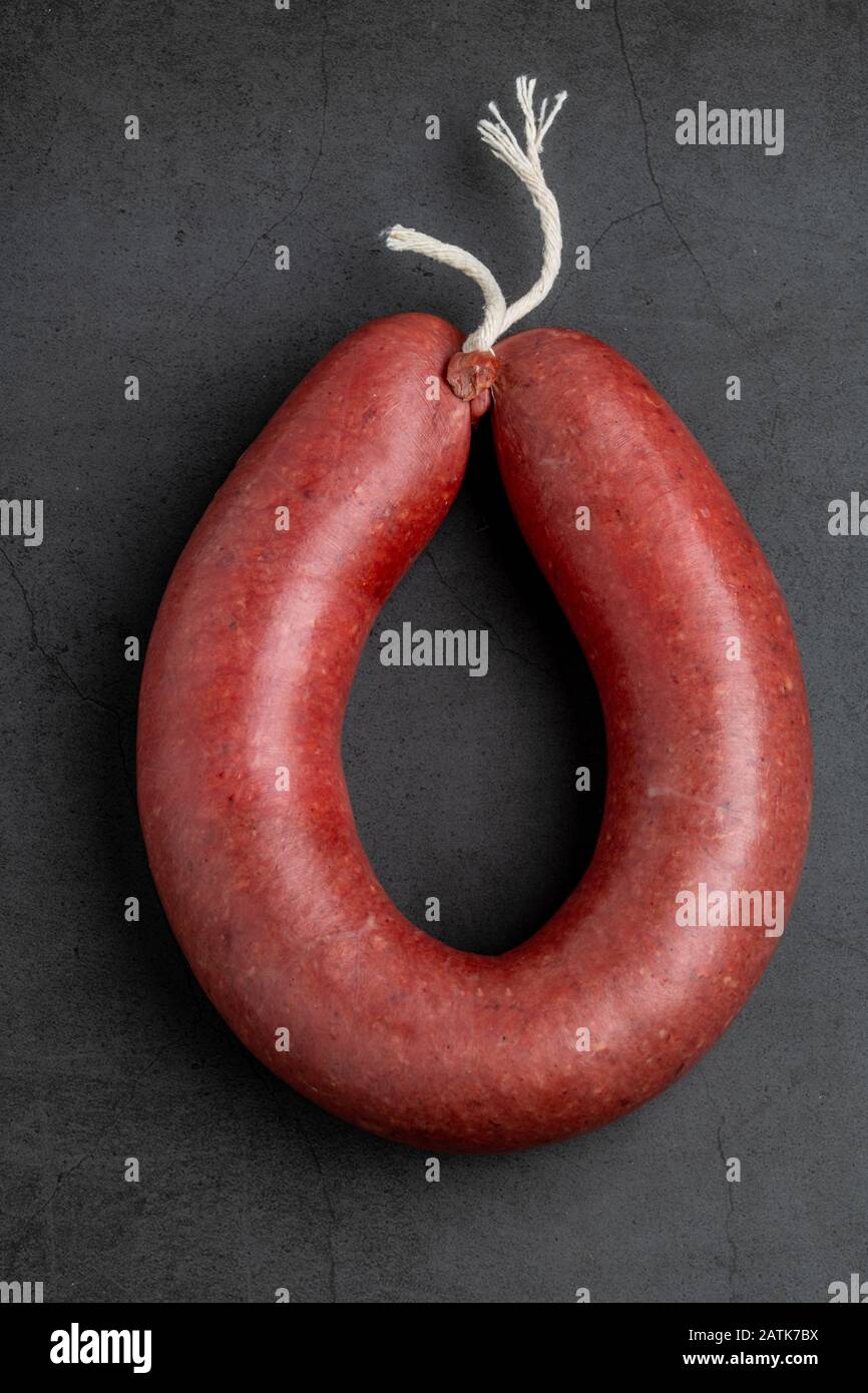 Turkish sausage kangal sausage. Dry spicy sausage on dark stone ...