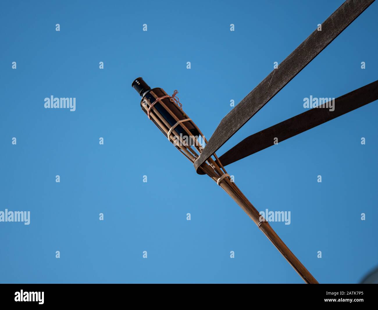 Old torch with blue sky background. close up Stock Photo - Alamy