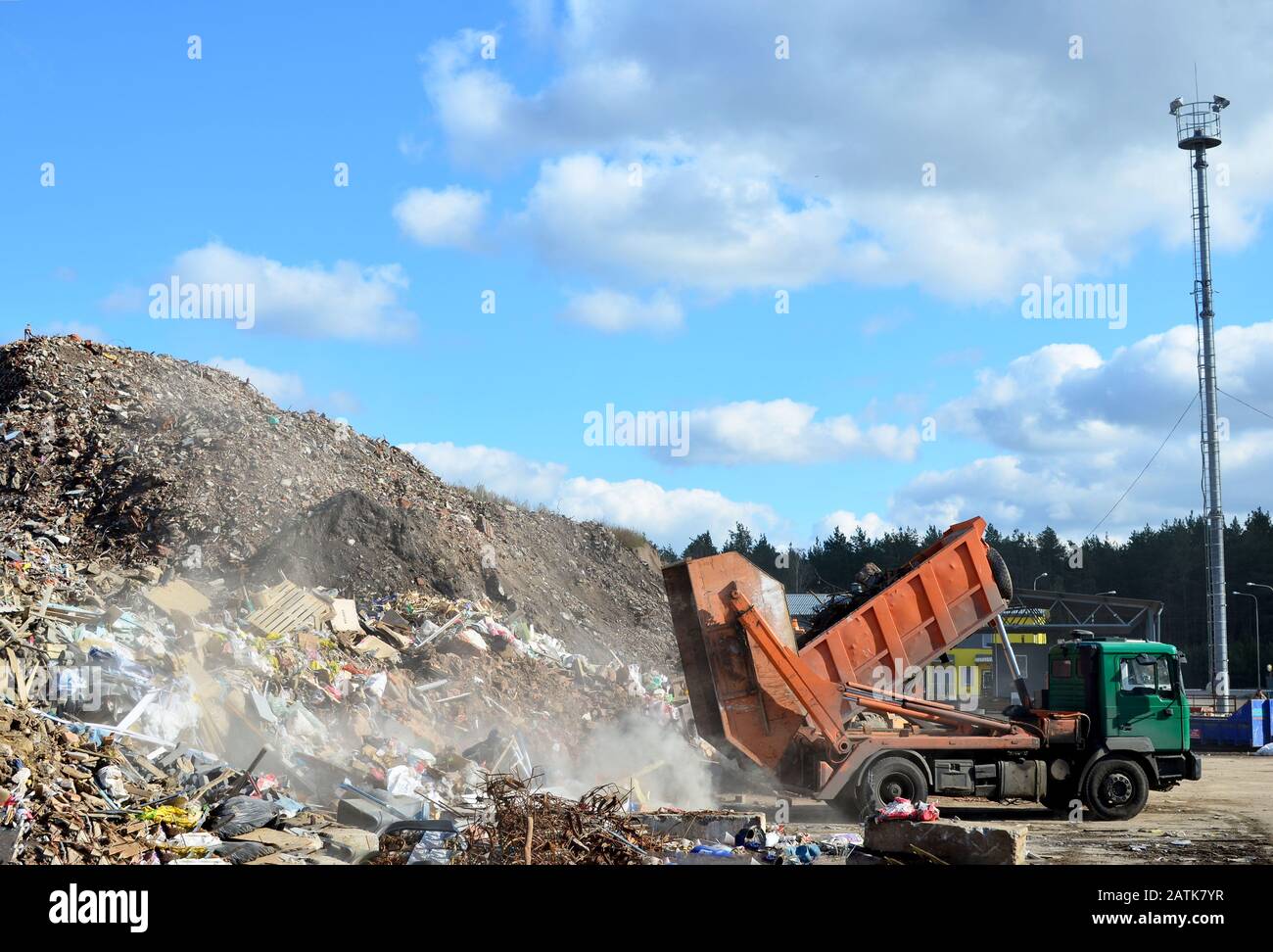 Garbage truck unloads construction waste from container at the landfill ...