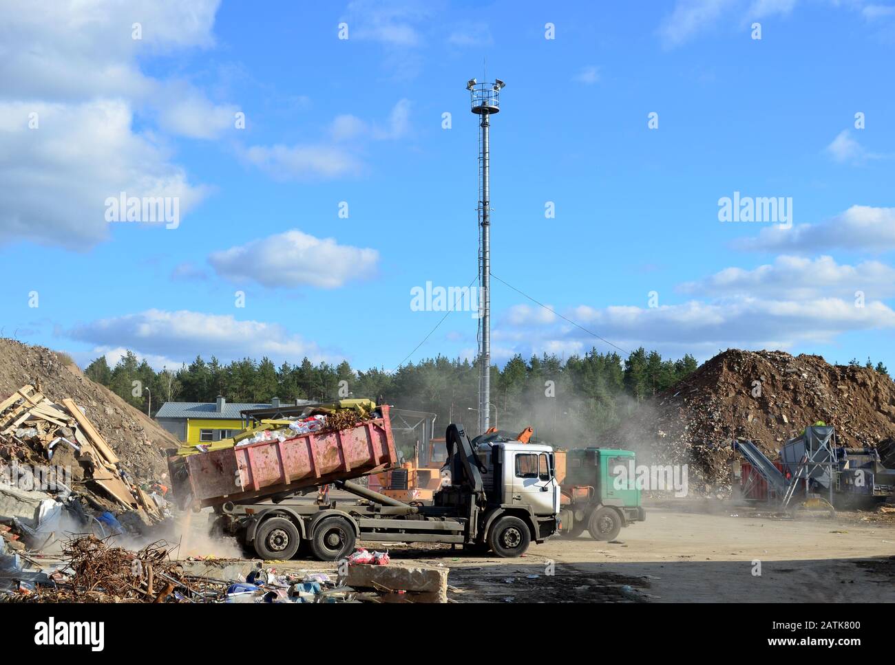 Garbage truck unloads construction waste from container at the landfill ...