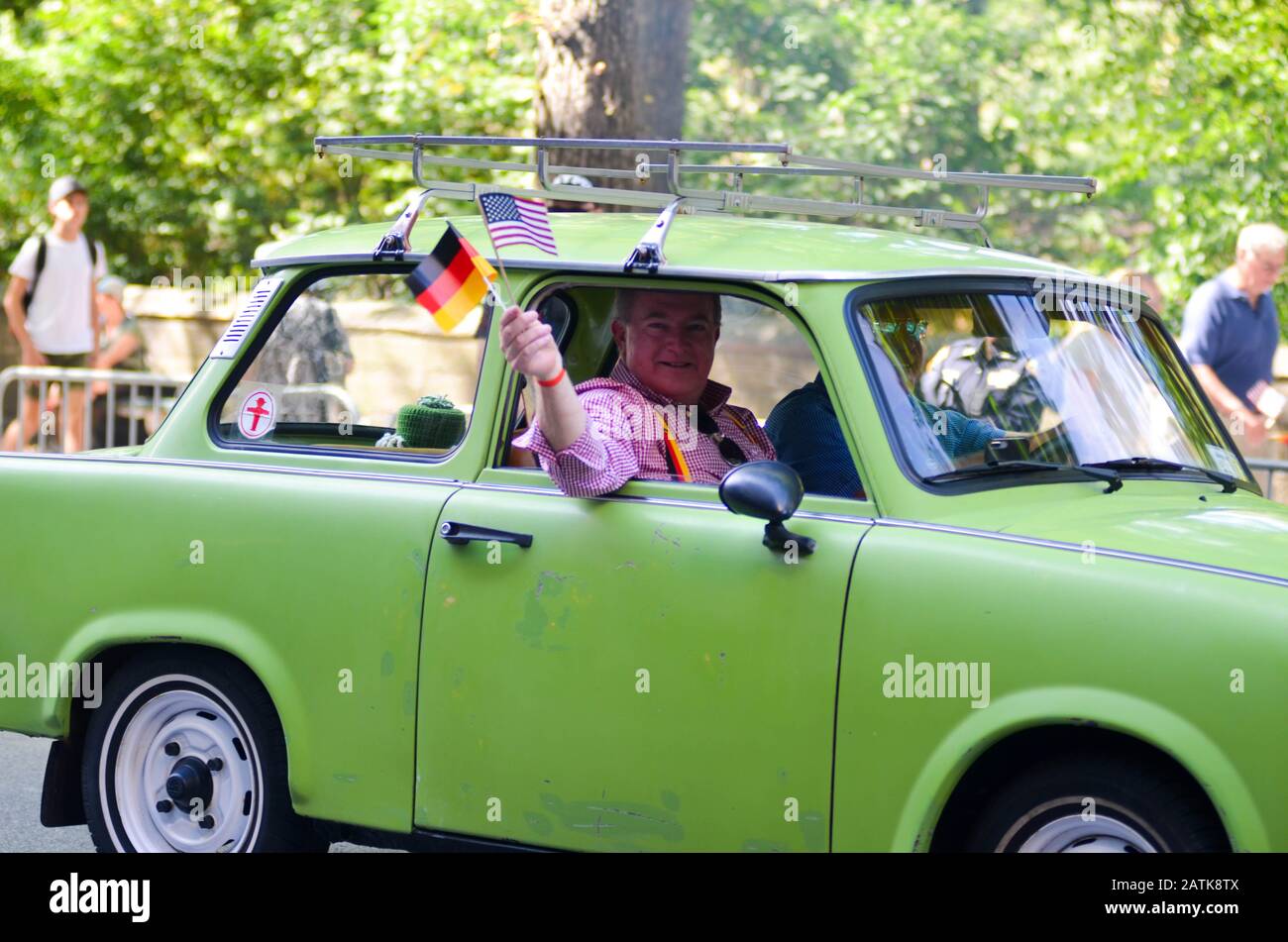 A Participant is seen waving German flag through car window during the ...