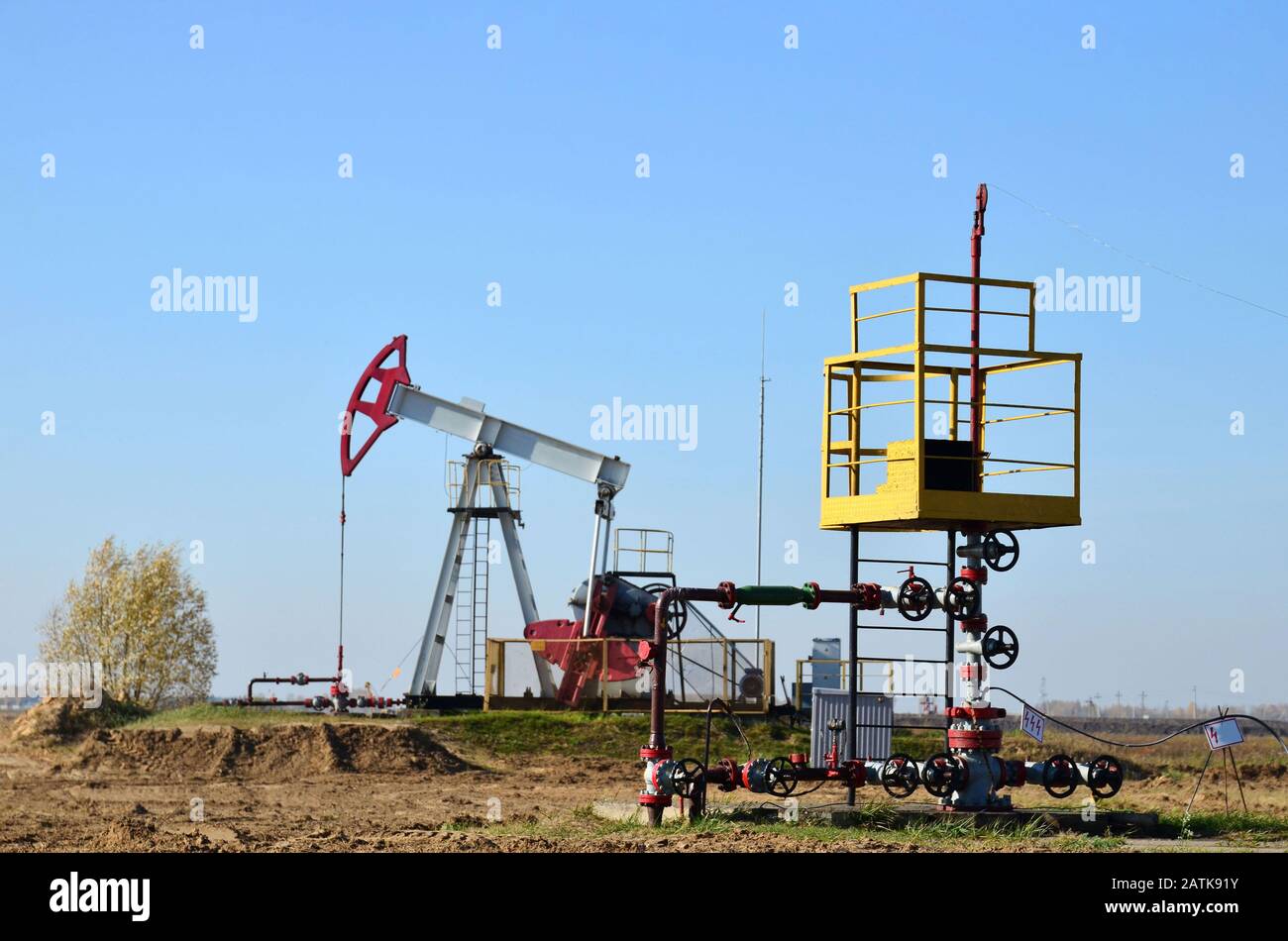 Oil drilling derricks at desert oilfield for fossil fuels output and ...