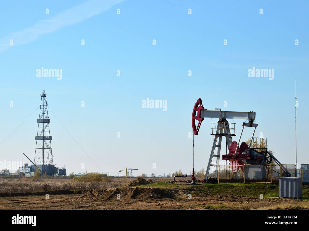 Oil drilling derricks at desert oilfield. Crude oil production from the ...