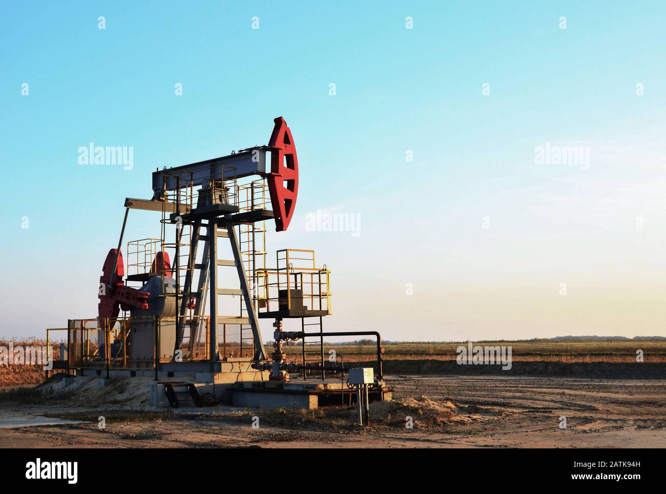 Oil drilling derricks at desert oilfield for fossil fuels output and ...