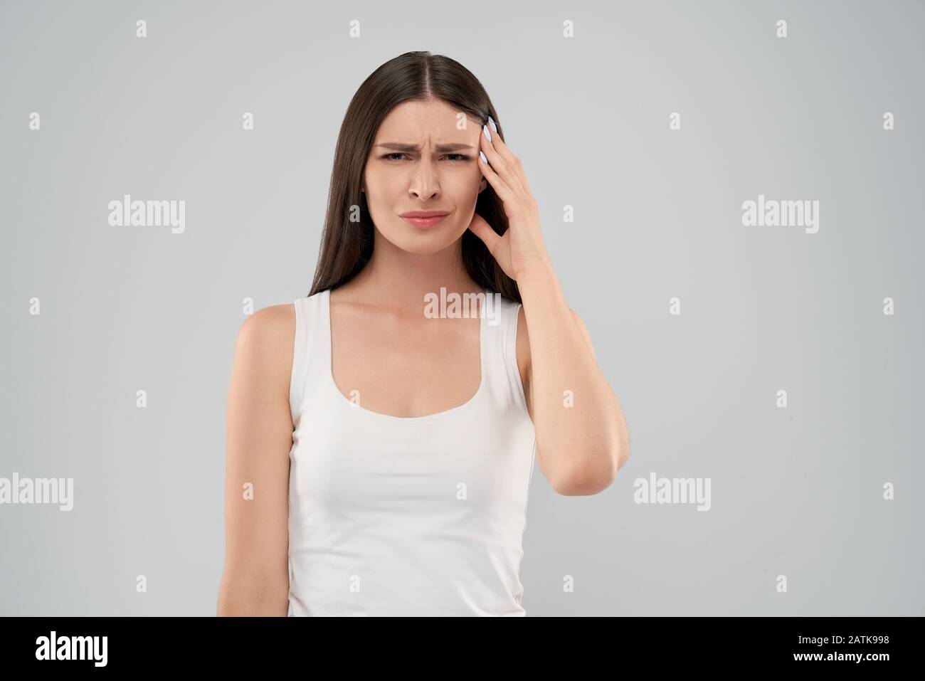 Young caucasian woman in white shirt over gray isolated background ...