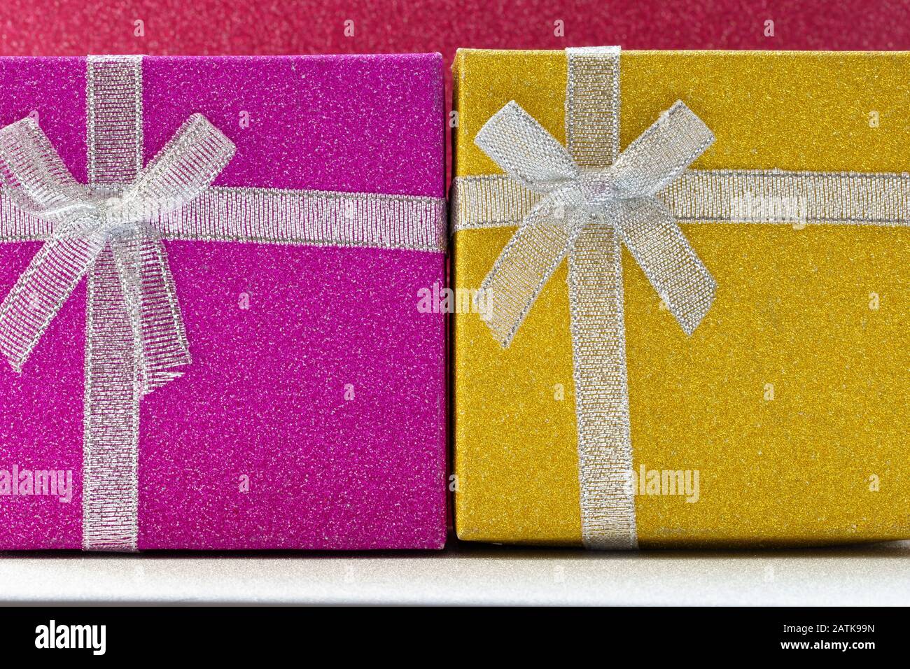 Yellow and purple Gift box with sparkling ribbon background Stock Photo ...