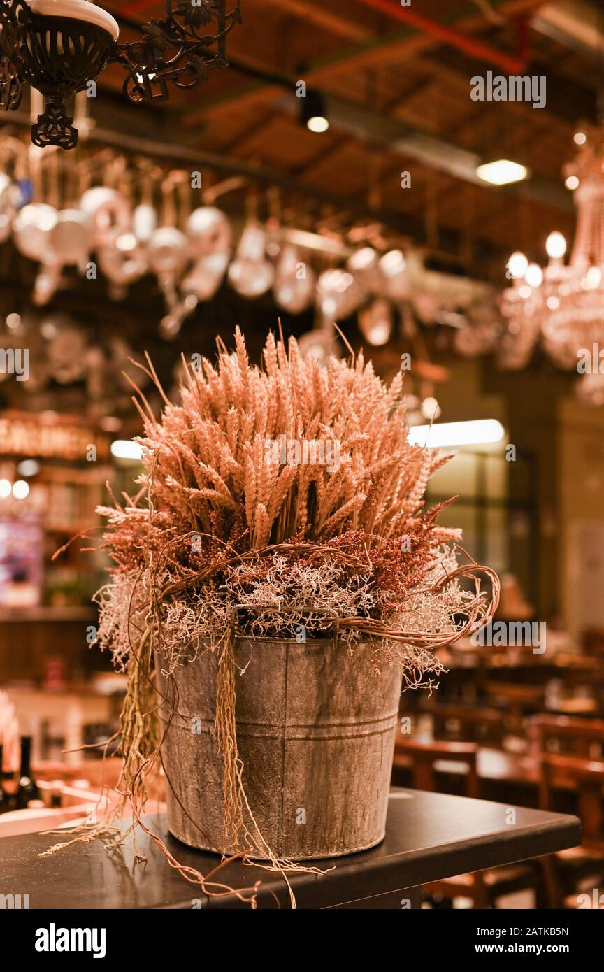 Decor of wheat in a restaurant. Vintage photo with tinted processing ...