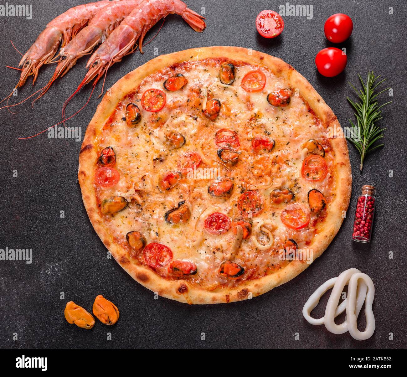 Seafood Italian pizza with shrimp, squid, mussels, fresh herbs and ...