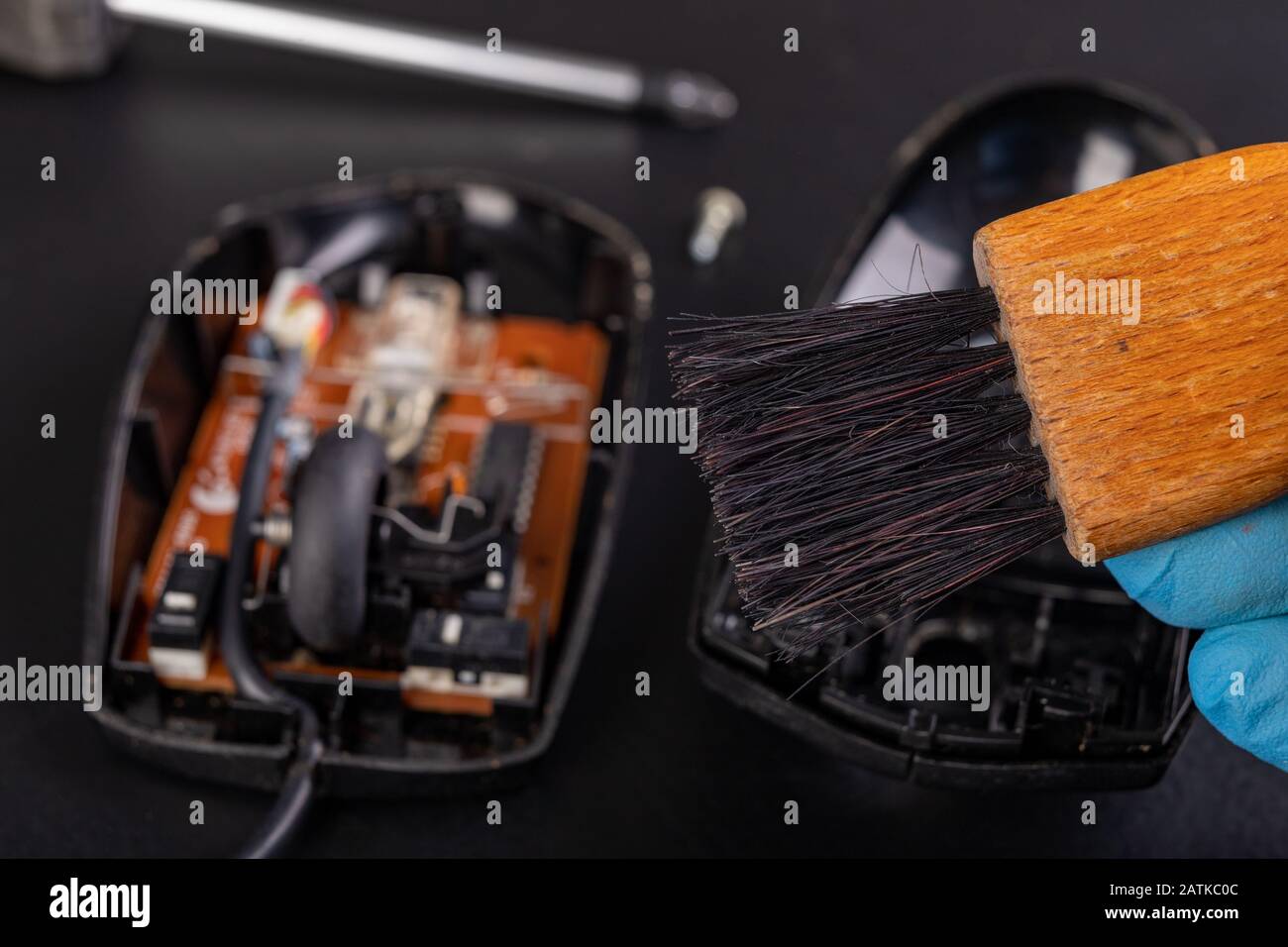 Cleaning of an optical computer mouse with a brush. Keeping the ...