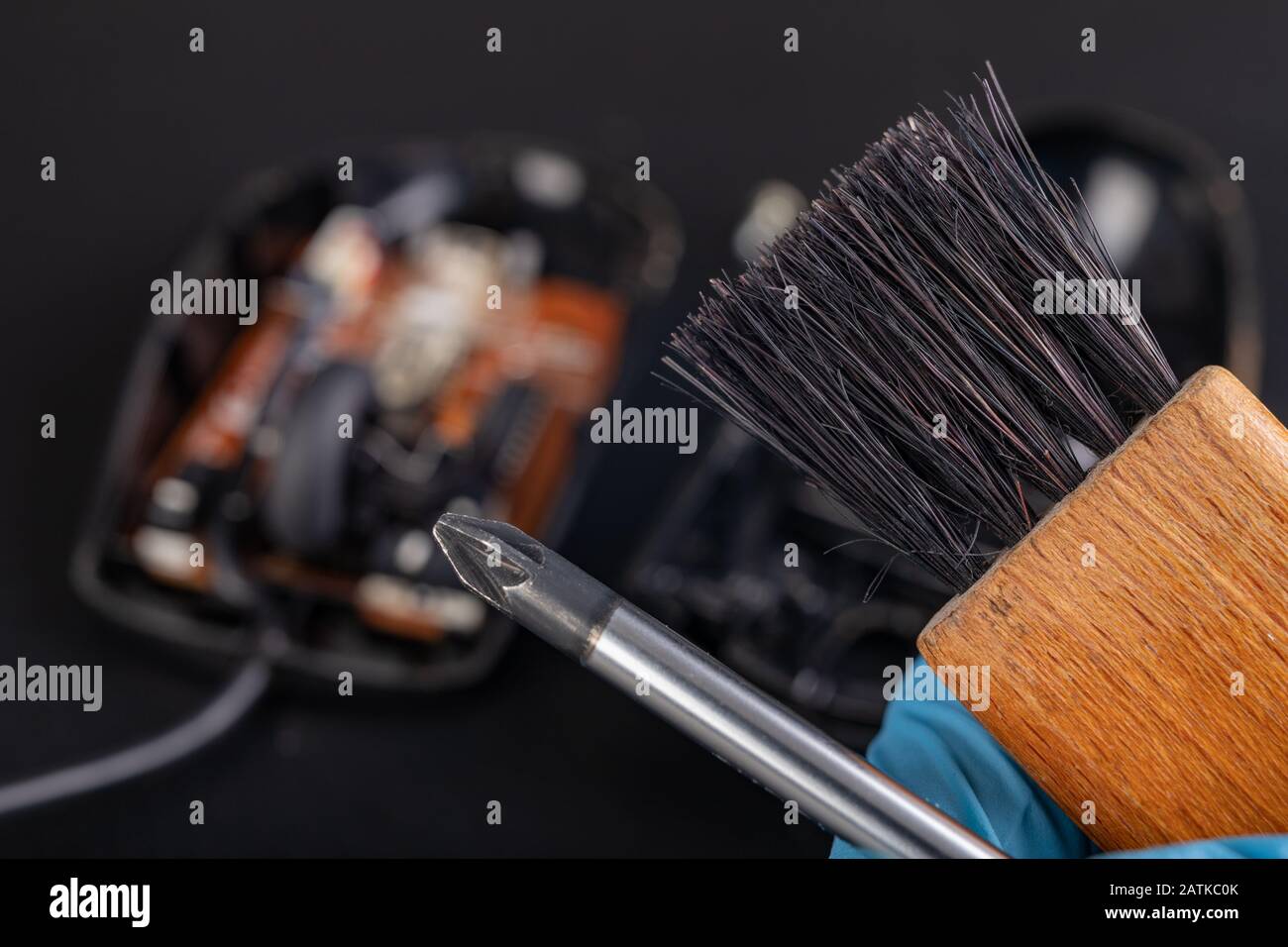 Cleaning of an optical computer mouse with a brush. Keeping the ...