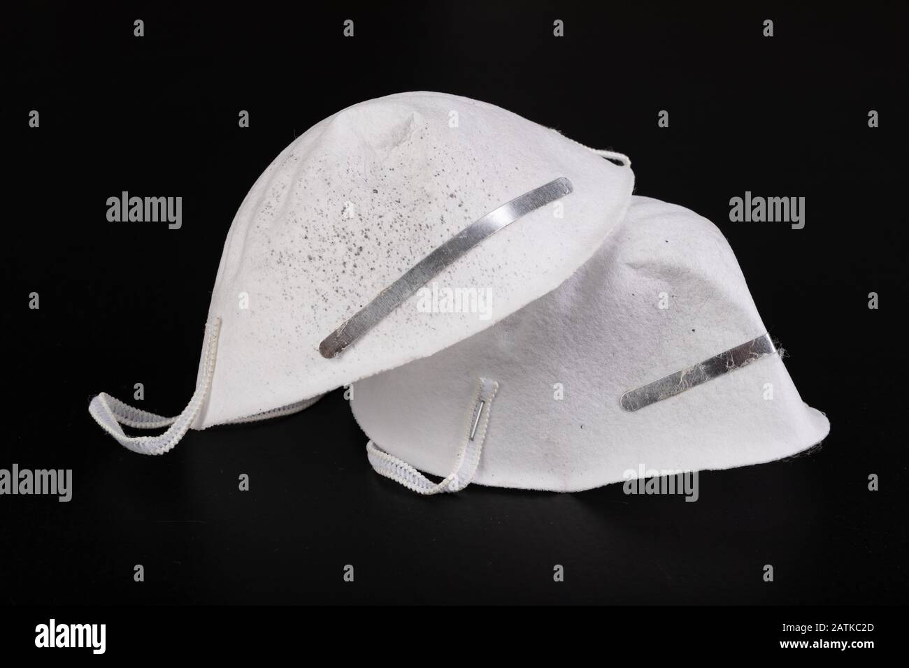 White dust mask. Respiratory protection at the workplace. Dark ...