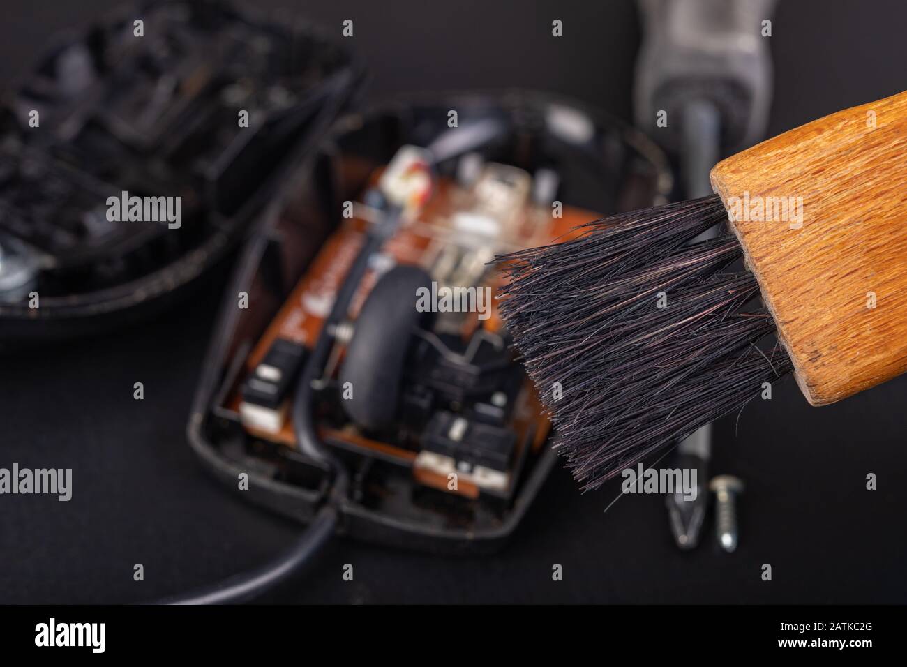 Cleaning of an optical computer mouse with a brush. Keeping the ...