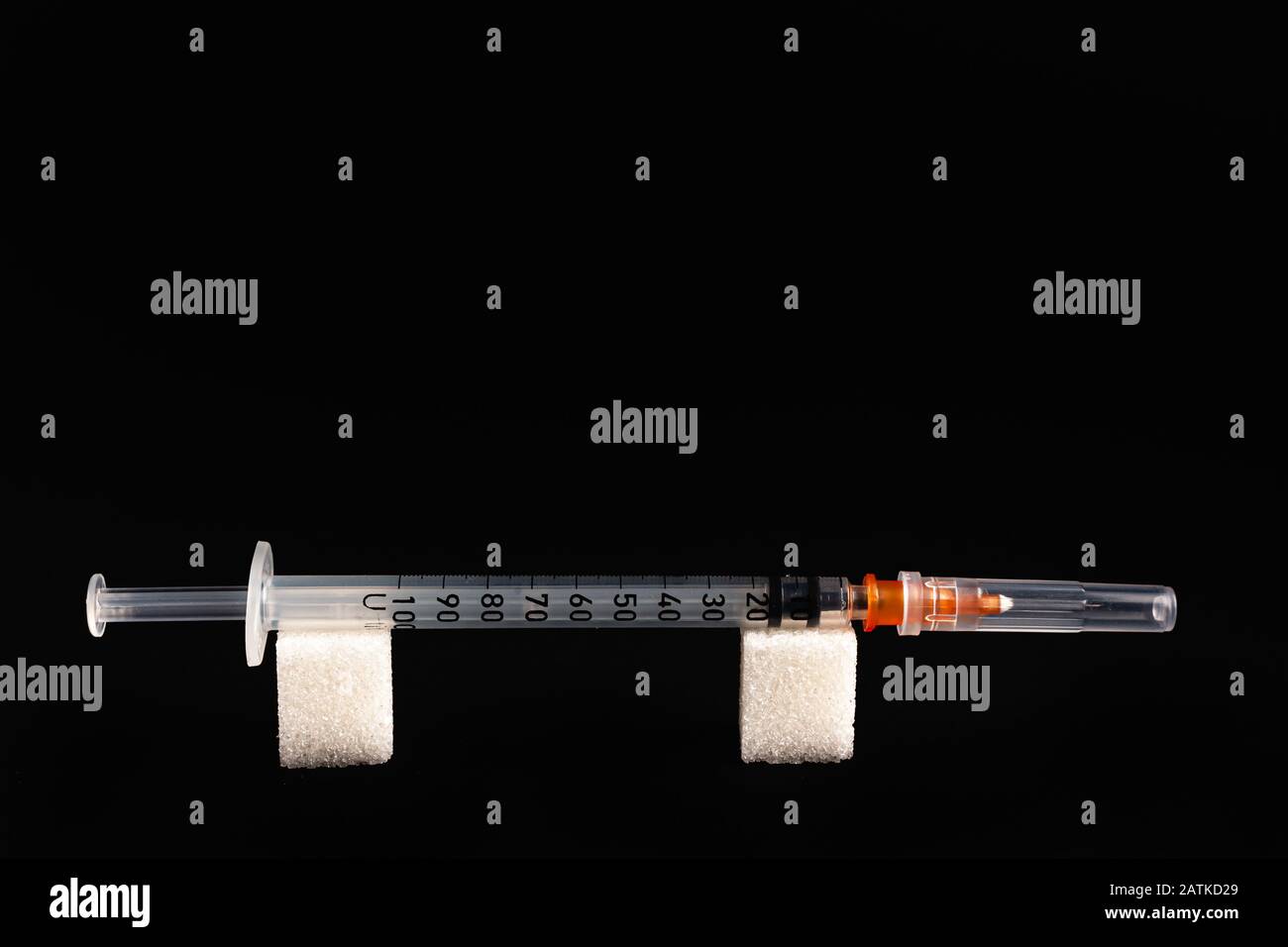An insulin syringe lies on cubes of sugar. Concept for developing ...