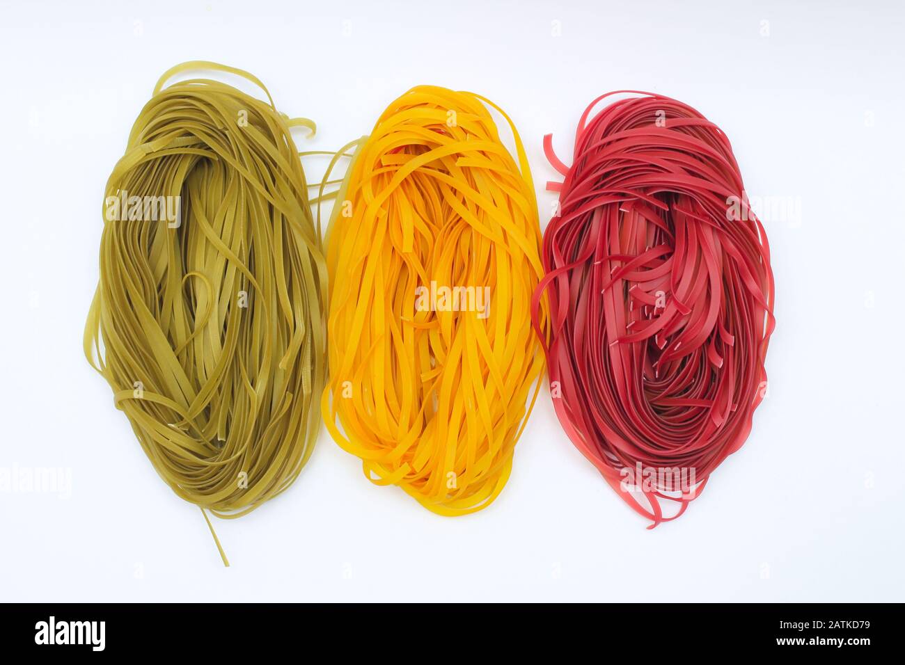 Isolated colored spaghetti nests on a white background Stock Photo - Alamy