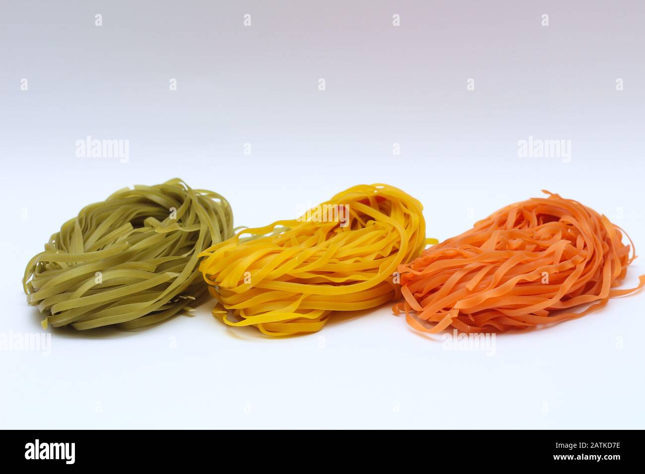 Isolated colored spaghetti nests on a white background Stock Photo - Alamy