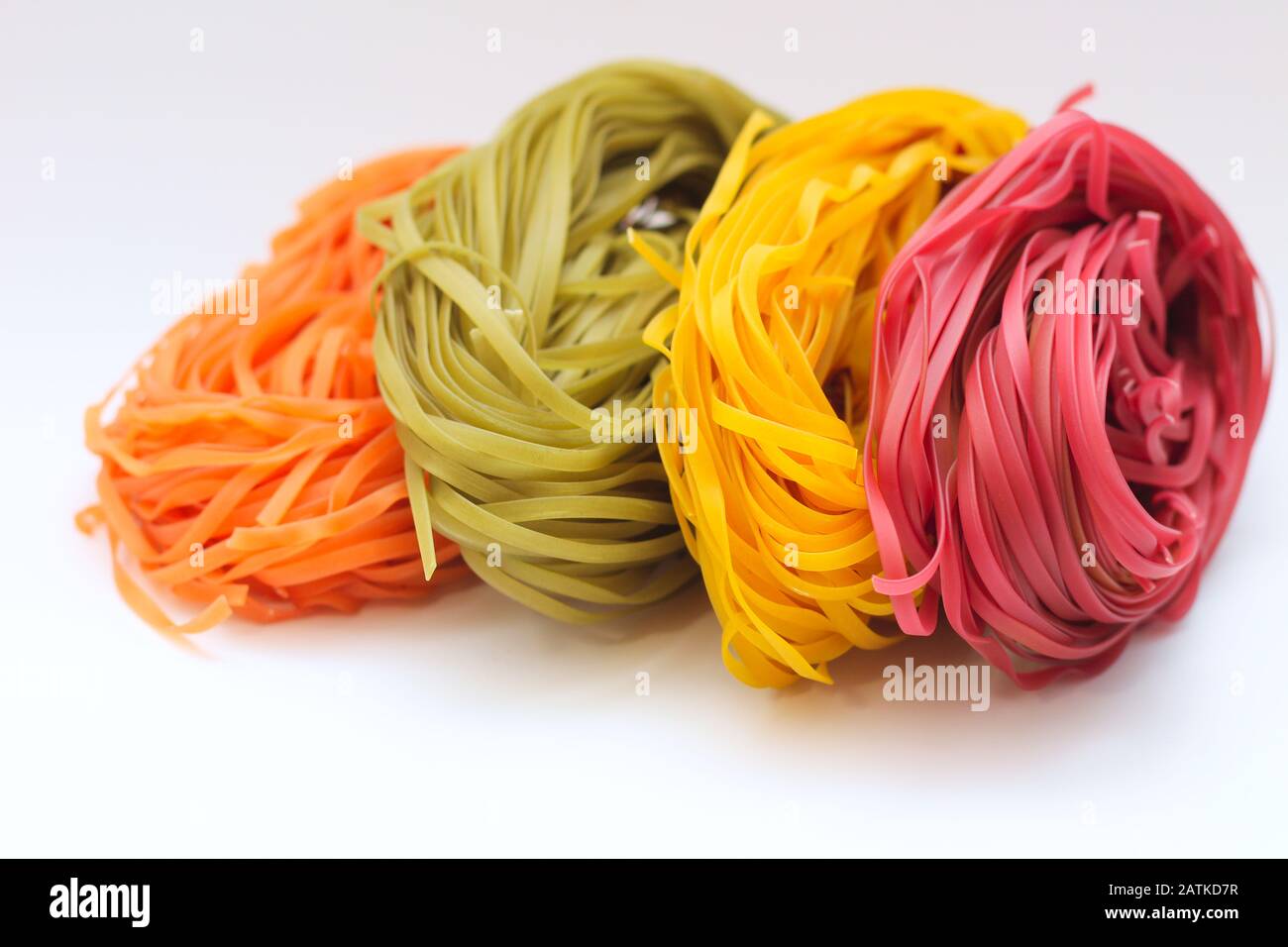Isolated colored spaghetti nests on a white background Stock Photo - Alamy