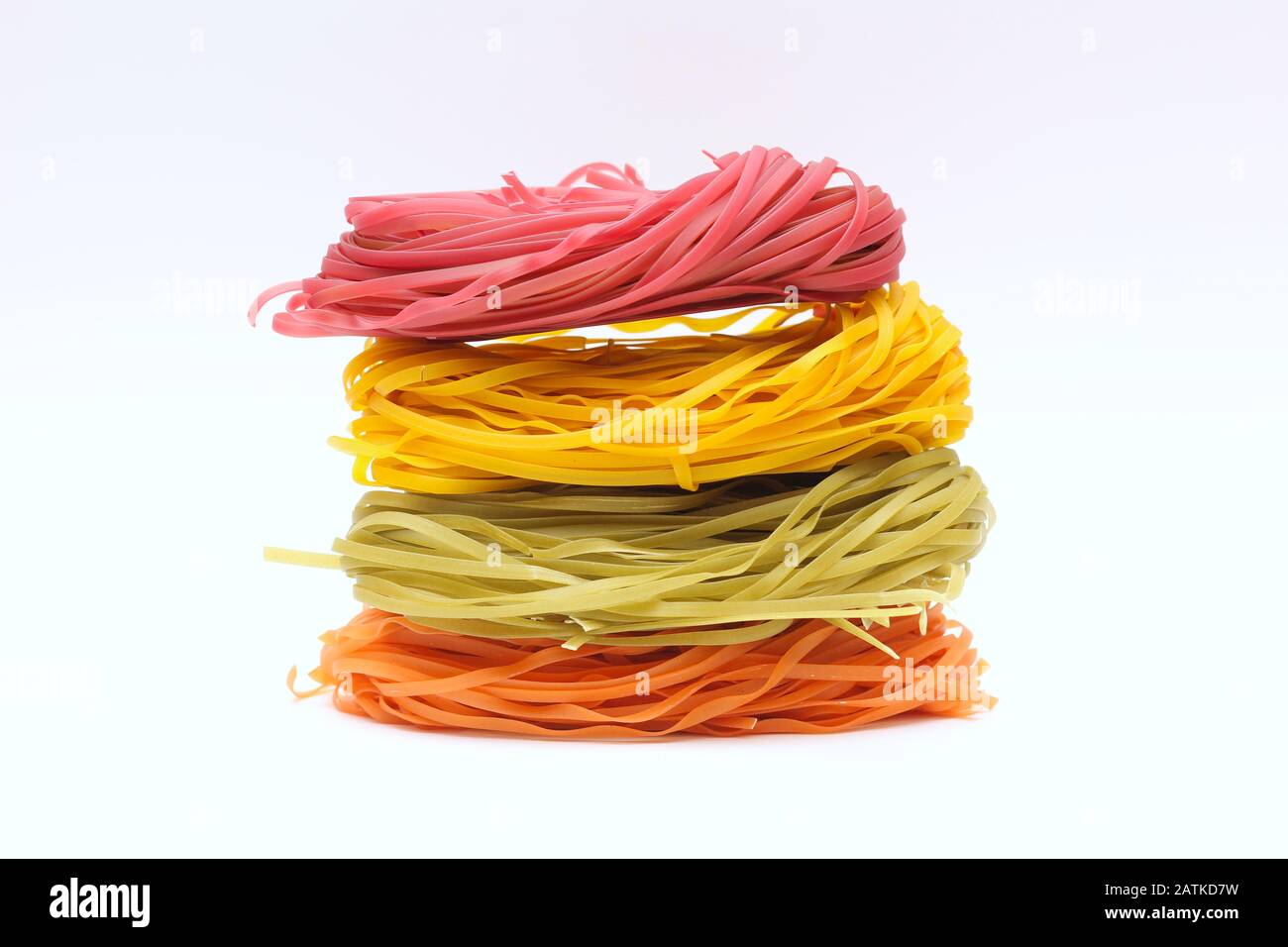 Isolated colored spaghetti nests on a white background Stock Photo - Alamy