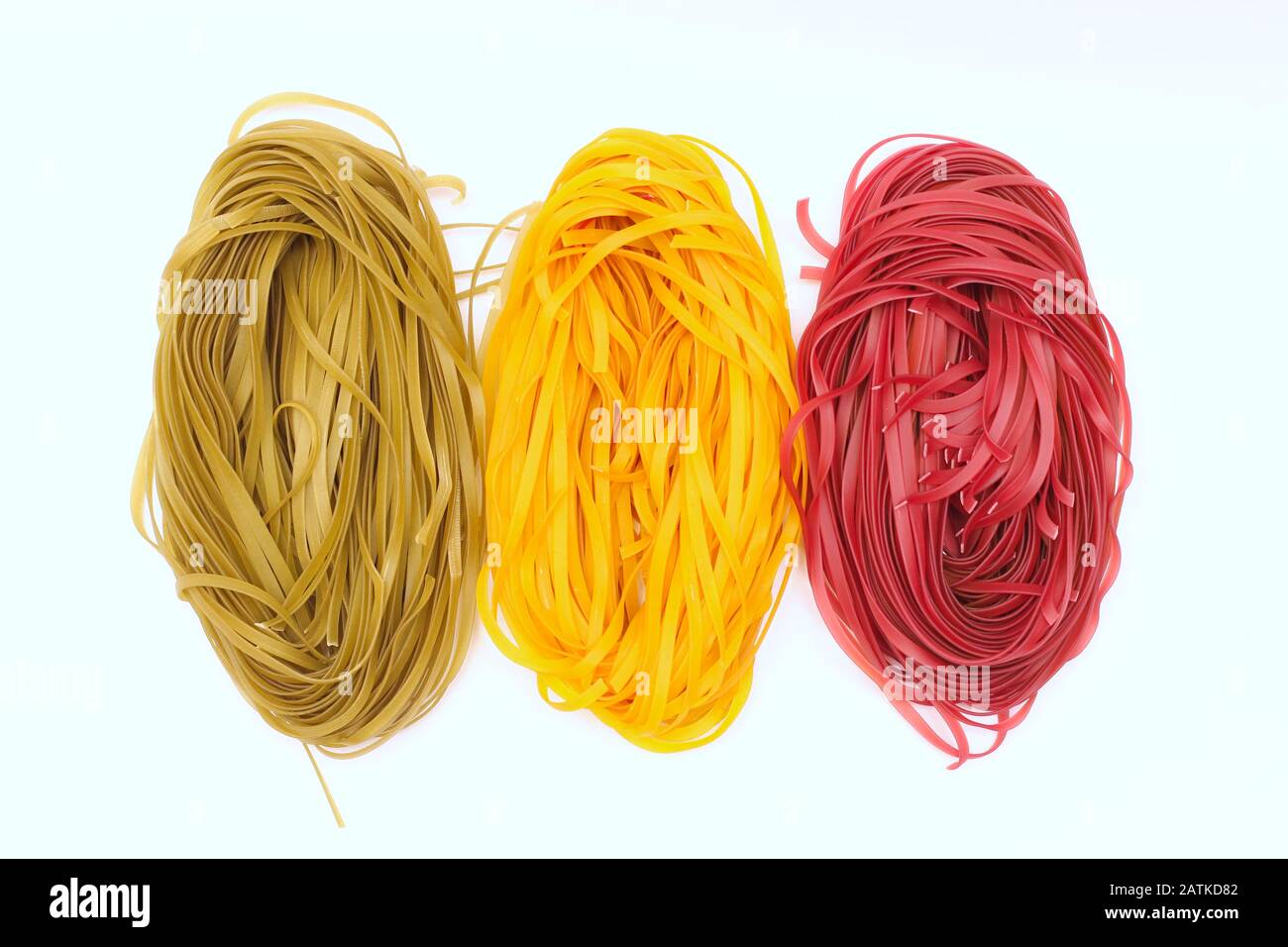 Isolated colored spaghetti nests on a white background Stock Photo - Alamy