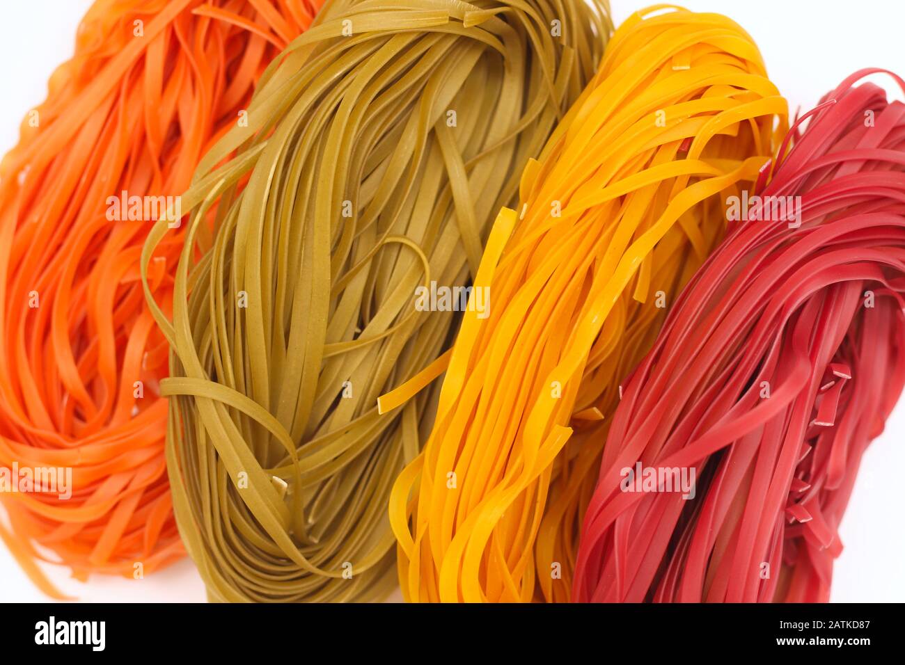 Isolated colored spaghetti nests on a white background Stock Photo - Alamy