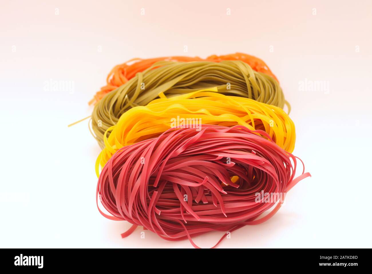 Isolated colored spaghetti nests on a white background Stock Photo - Alamy