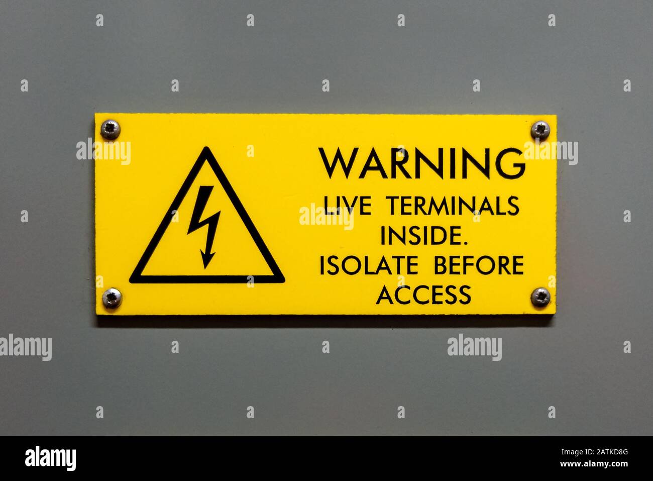 Live terminals inside isolate before access yellow warning sign Stock ...