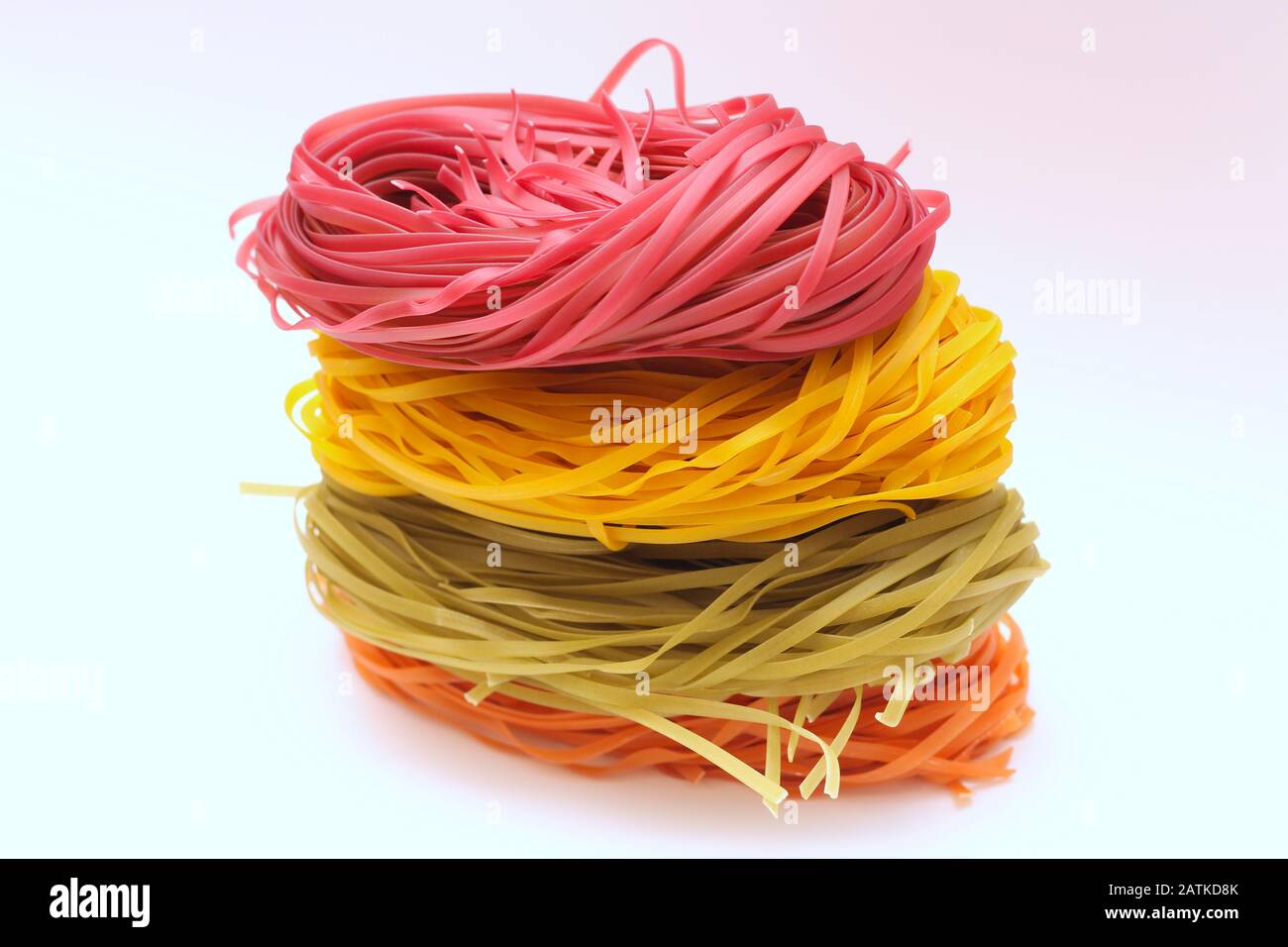 Isolated colored spaghetti nests on a white background Stock Photo - Alamy