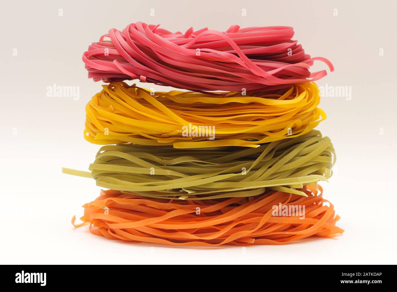 Isolated colored spaghetti nests on a white background Stock Photo - Alamy