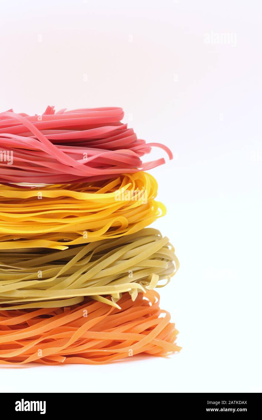 Isolated colored spaghetti nests on a white background Stock Photo - Alamy