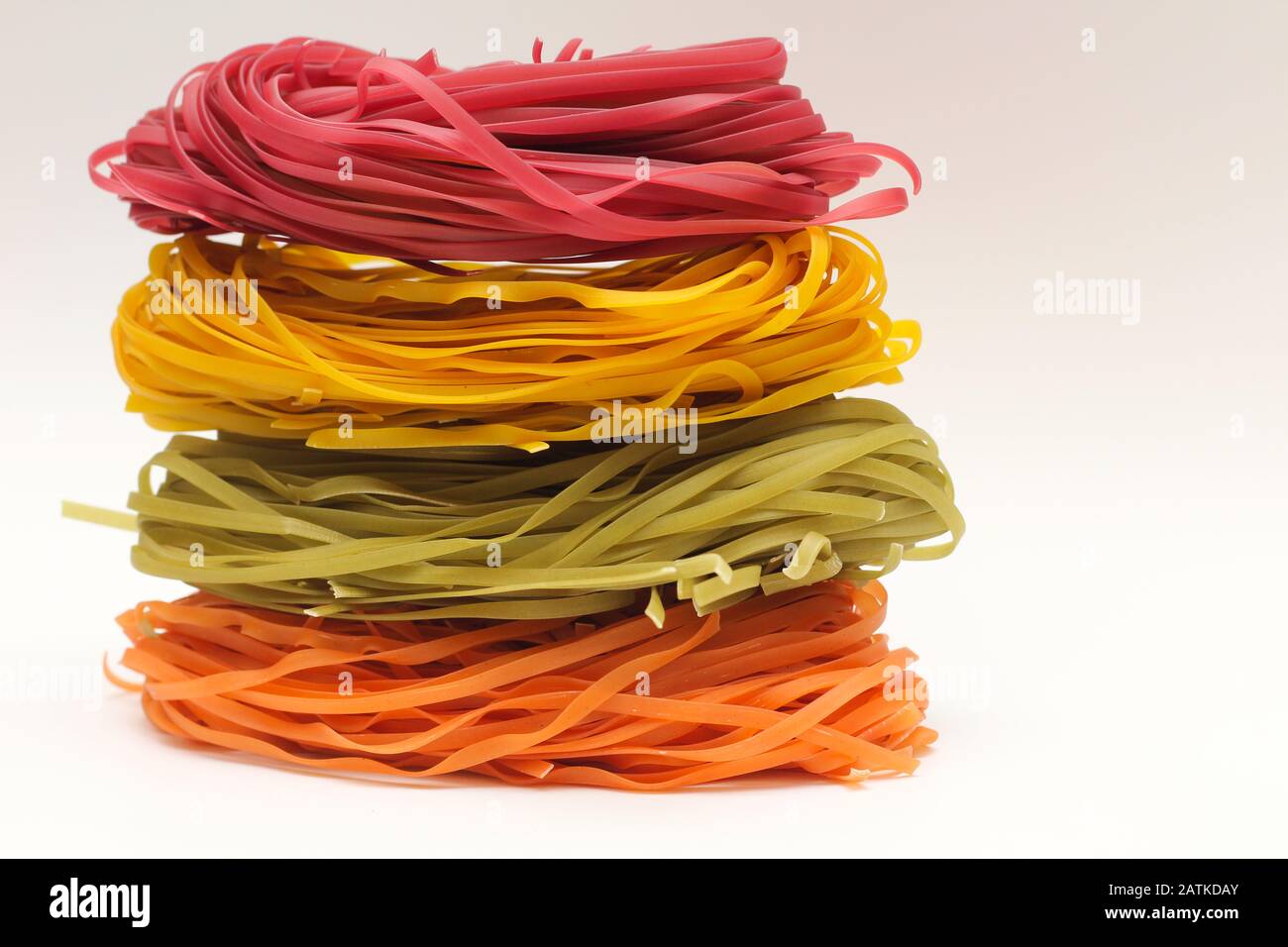 Isolated colored spaghetti nests on a white background Stock Photo - Alamy