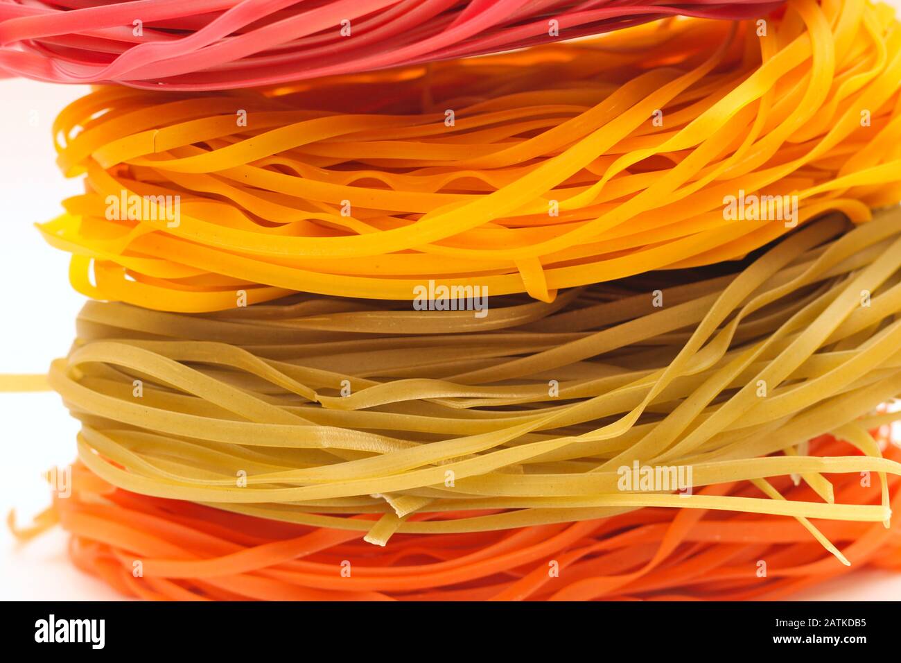 Isolated colored spaghetti nests on a white background Stock Photo - Alamy