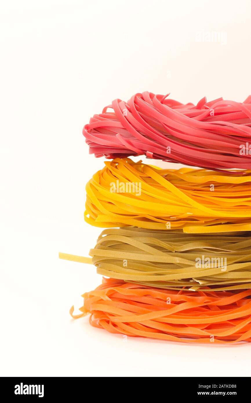 Isolated colored spaghetti nests on a white background Stock Photo - Alamy