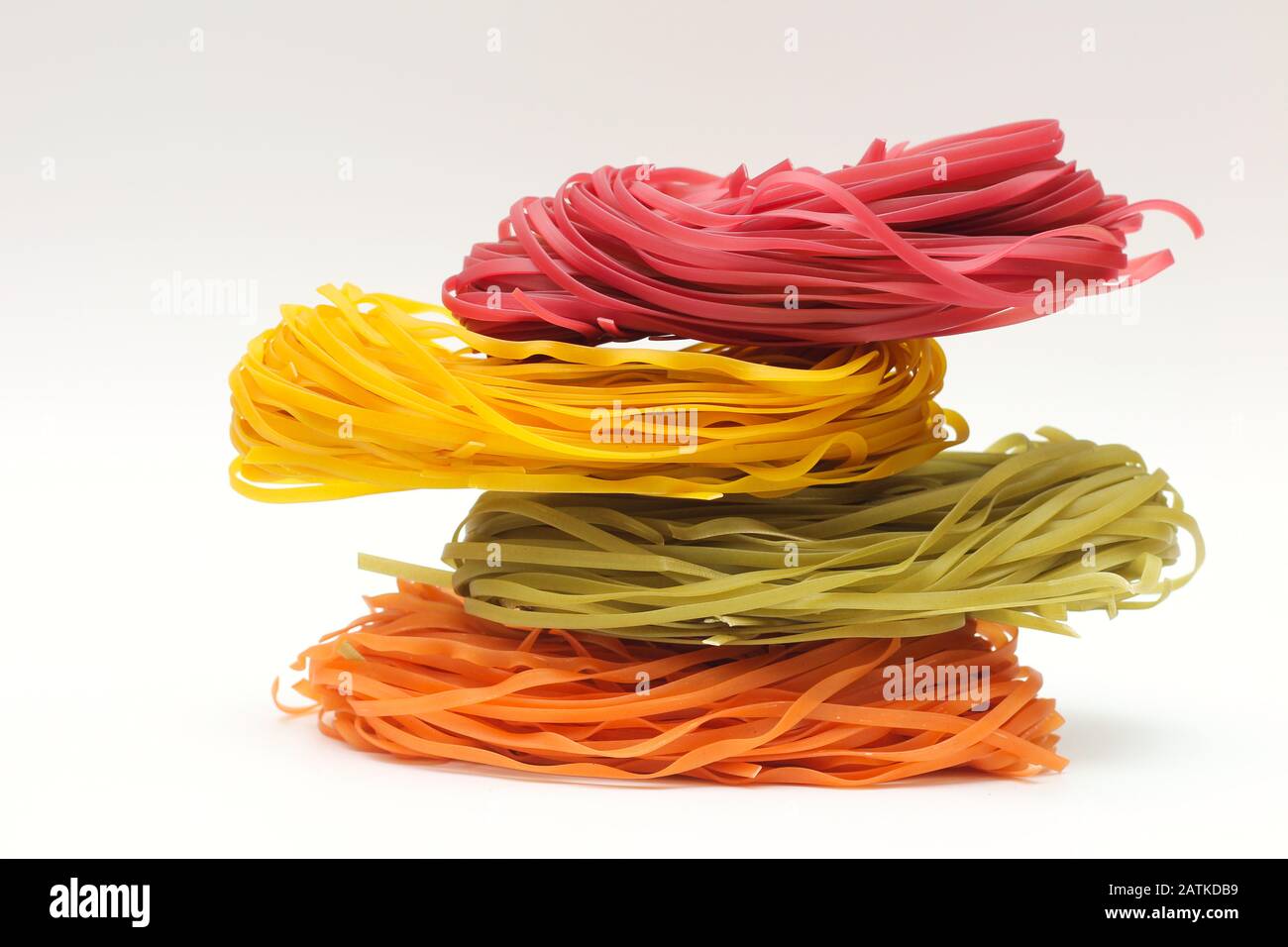 Isolated colored spaghetti nests on a white background Stock Photo - Alamy