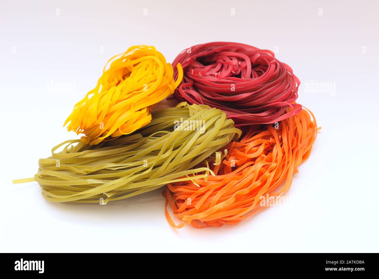Isolated colored spaghetti nests on a white background Stock Photo - Alamy
