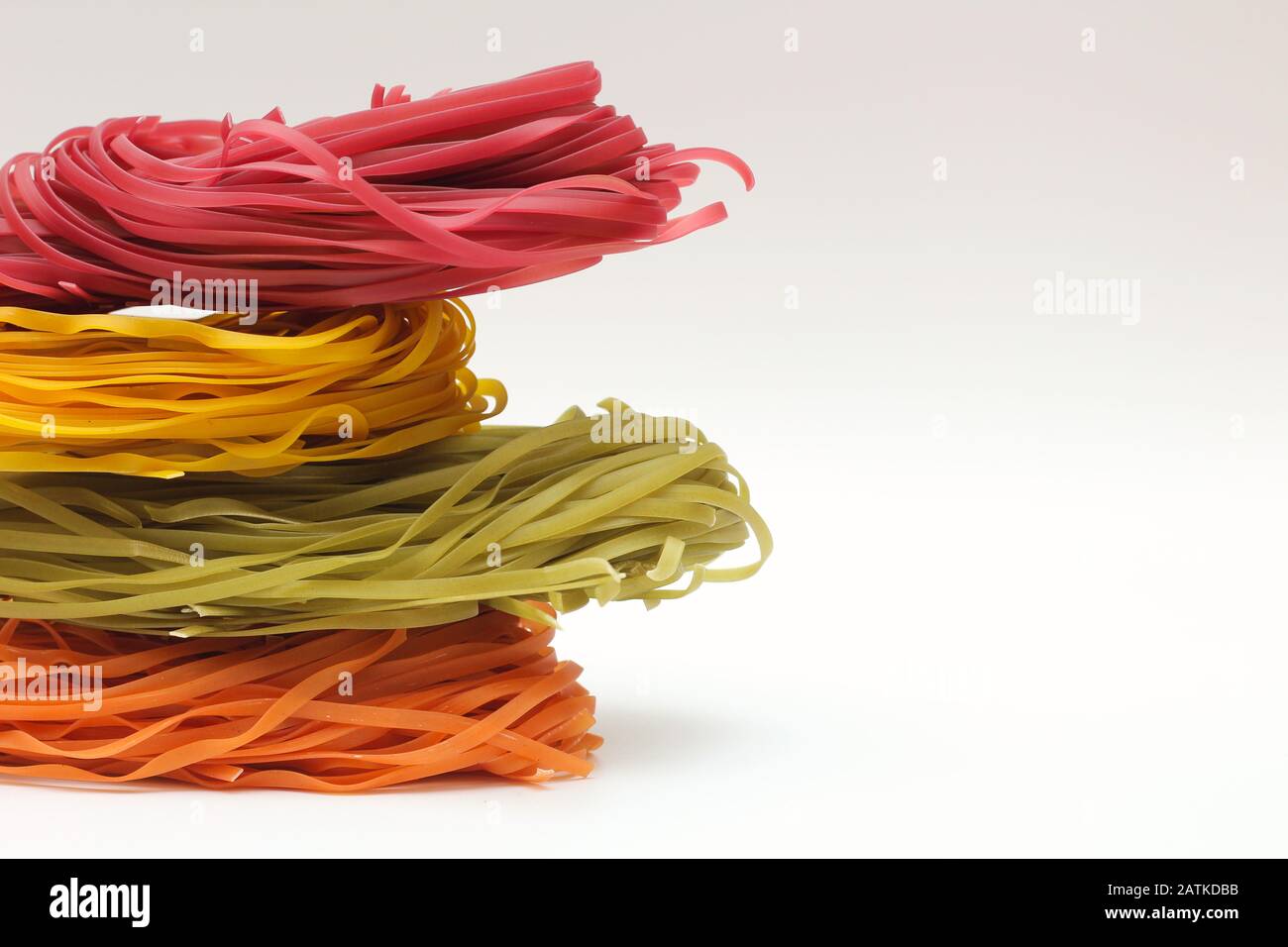 Isolated colored spaghetti nests on a white background Stock Photo - Alamy