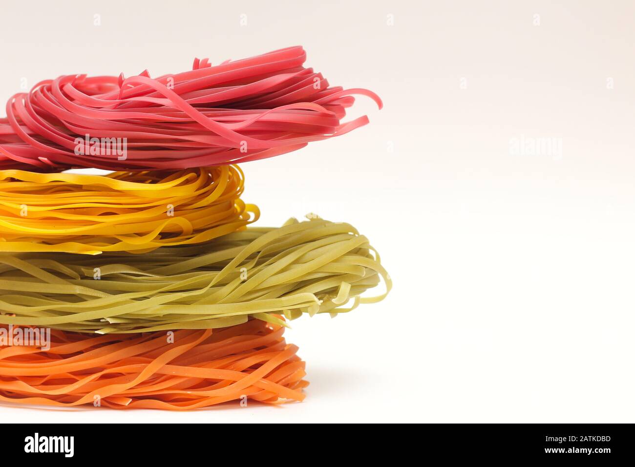 Isolated colored spaghetti nests on a white background Stock Photo - Alamy