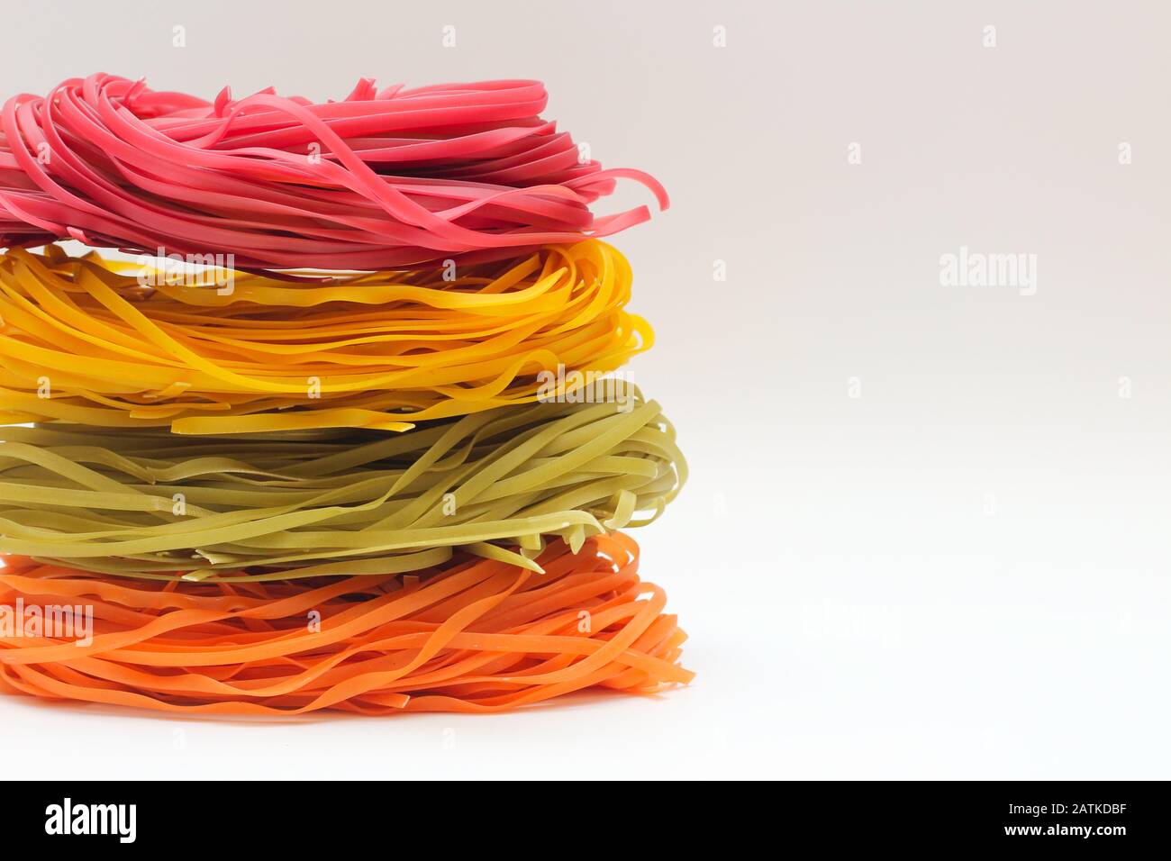 Isolated colored spaghetti nests on a white background Stock Photo - Alamy