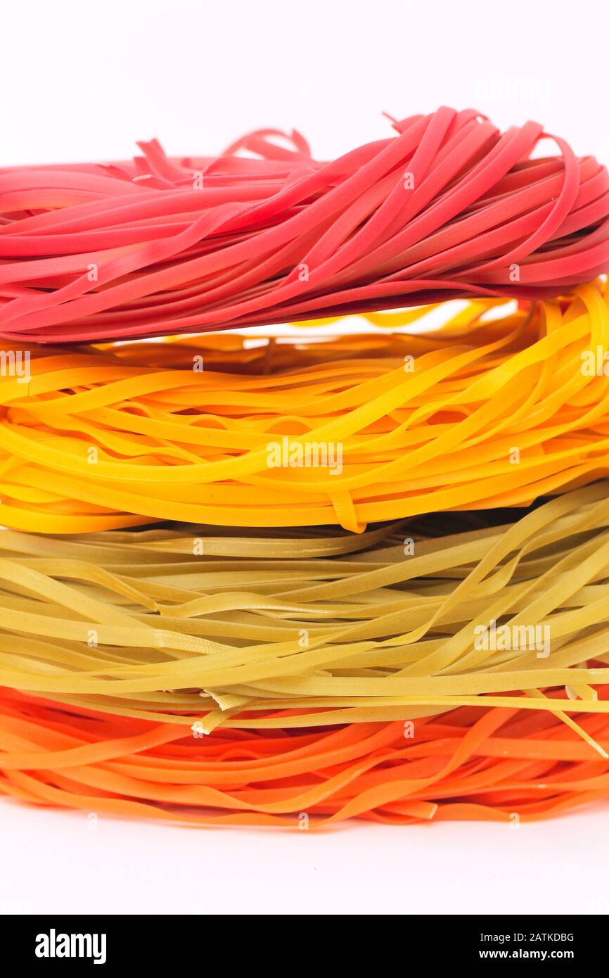 Isolated colored spaghetti nests on a white background Stock Photo - Alamy