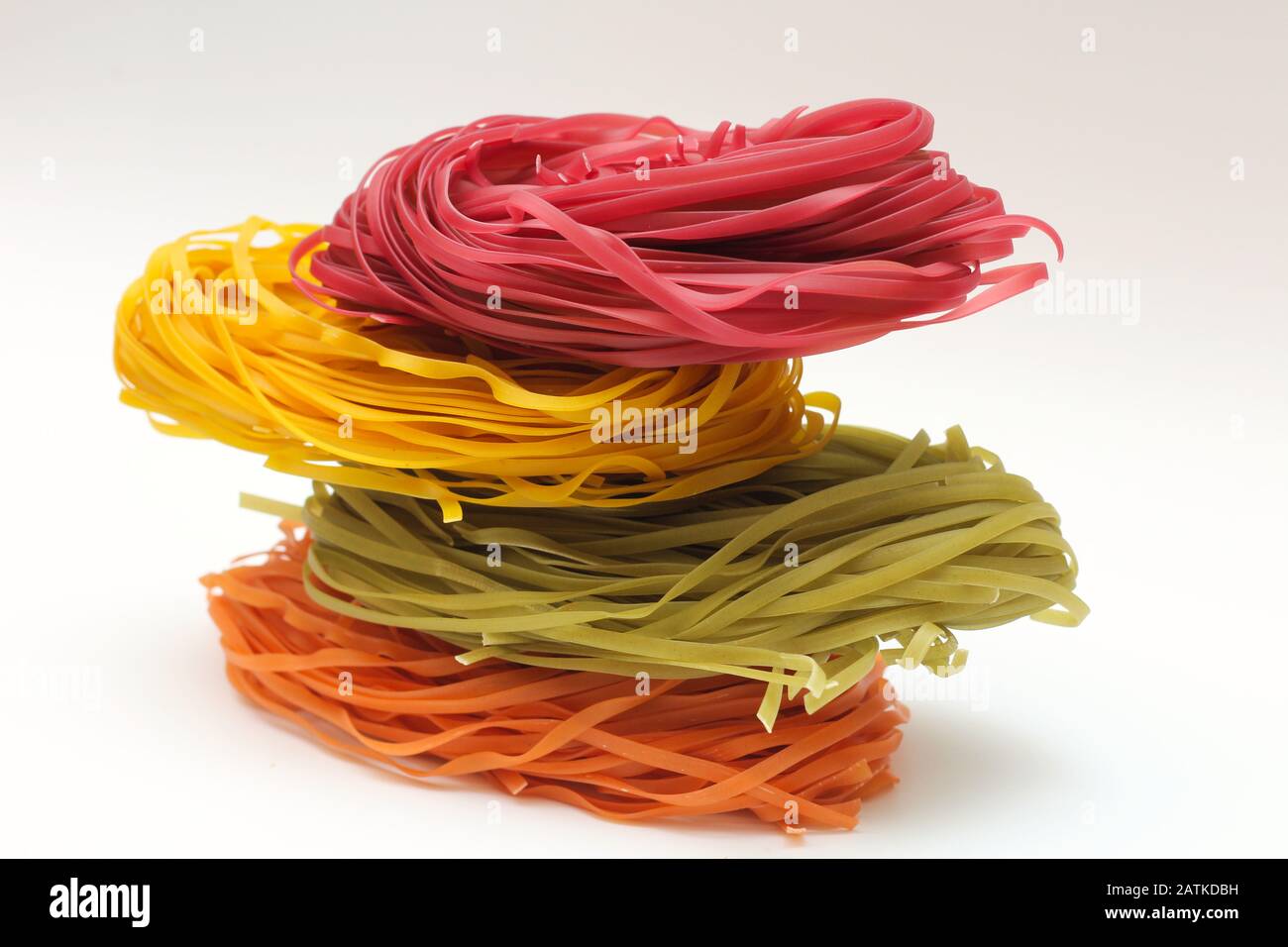 Isolated colored spaghetti nests on a white background Stock Photo - Alamy