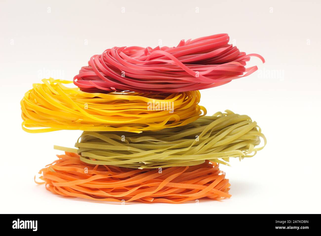 Isolated colored spaghetti nests on a white background Stock Photo - Alamy