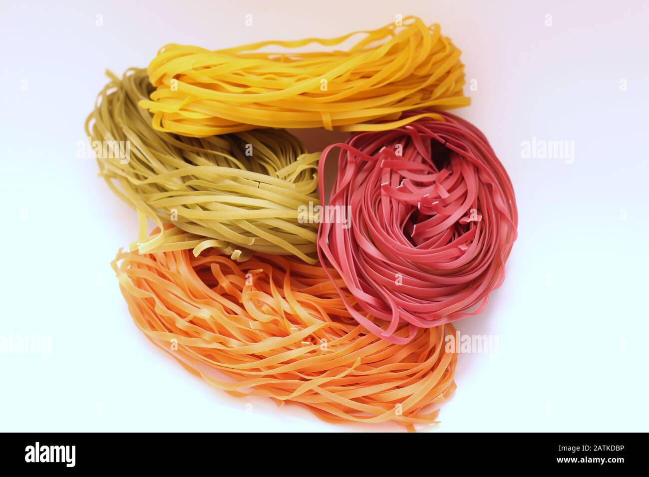 Isolated colored spaghetti nests on a white background Stock Photo - Alamy