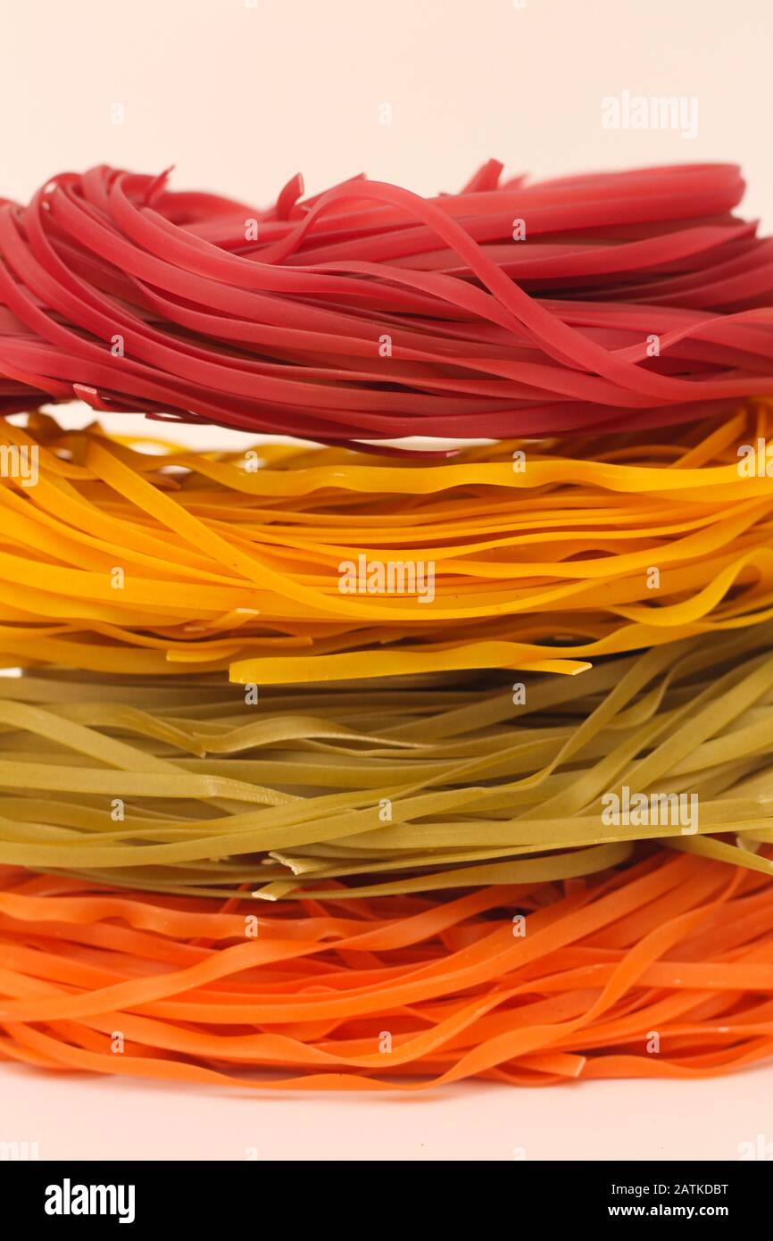 Isolated colored spaghetti nests on a white background Stock Photo - Alamy
