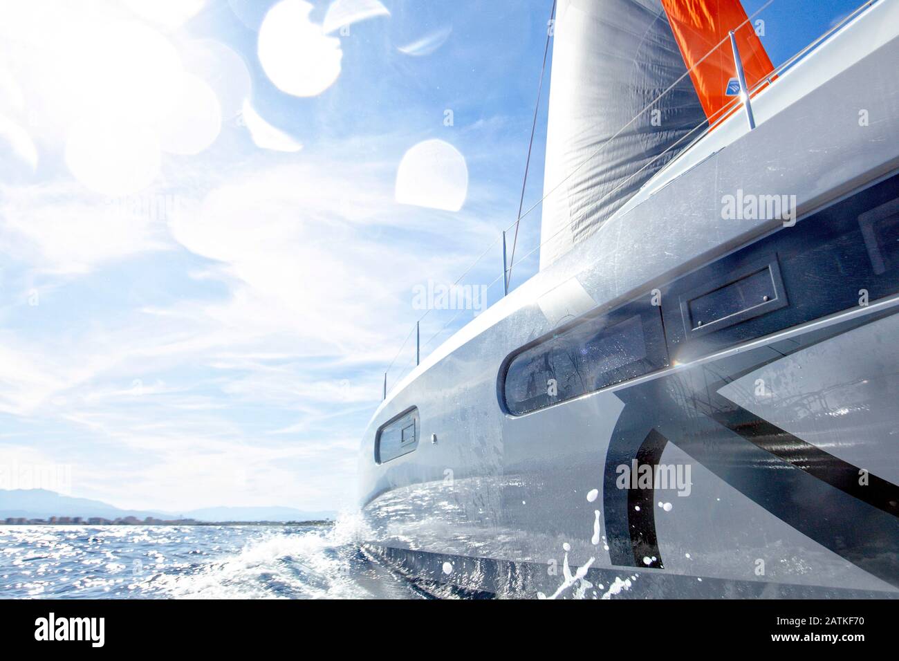 Hull of a cruising catamaran under sails by a beautiful sunny day Stock ...
