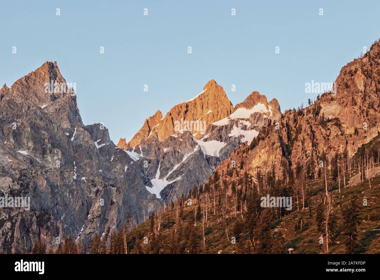 Alpenglow its the jagged summit of the Grand Teton at sunrise Stock ...