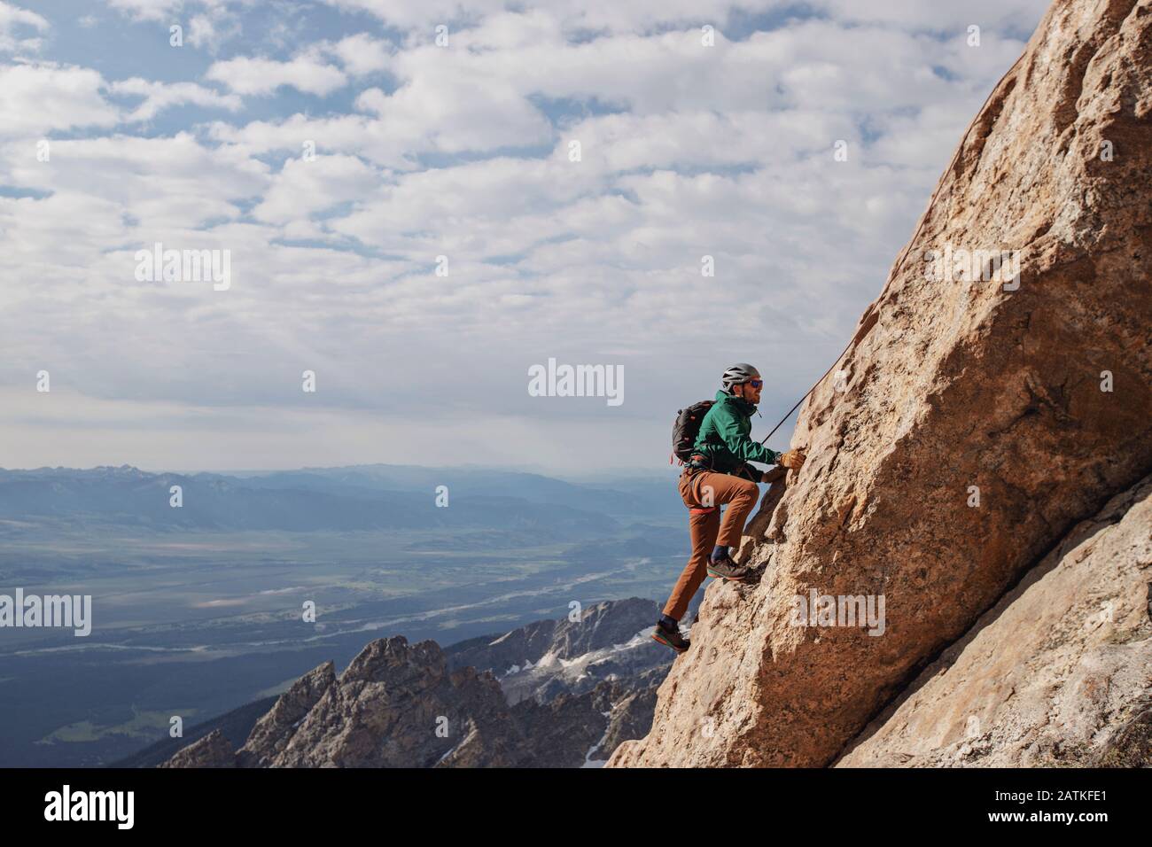 Male rock climber ascends the Exum Ridge route on the Grand Teton Stock ...