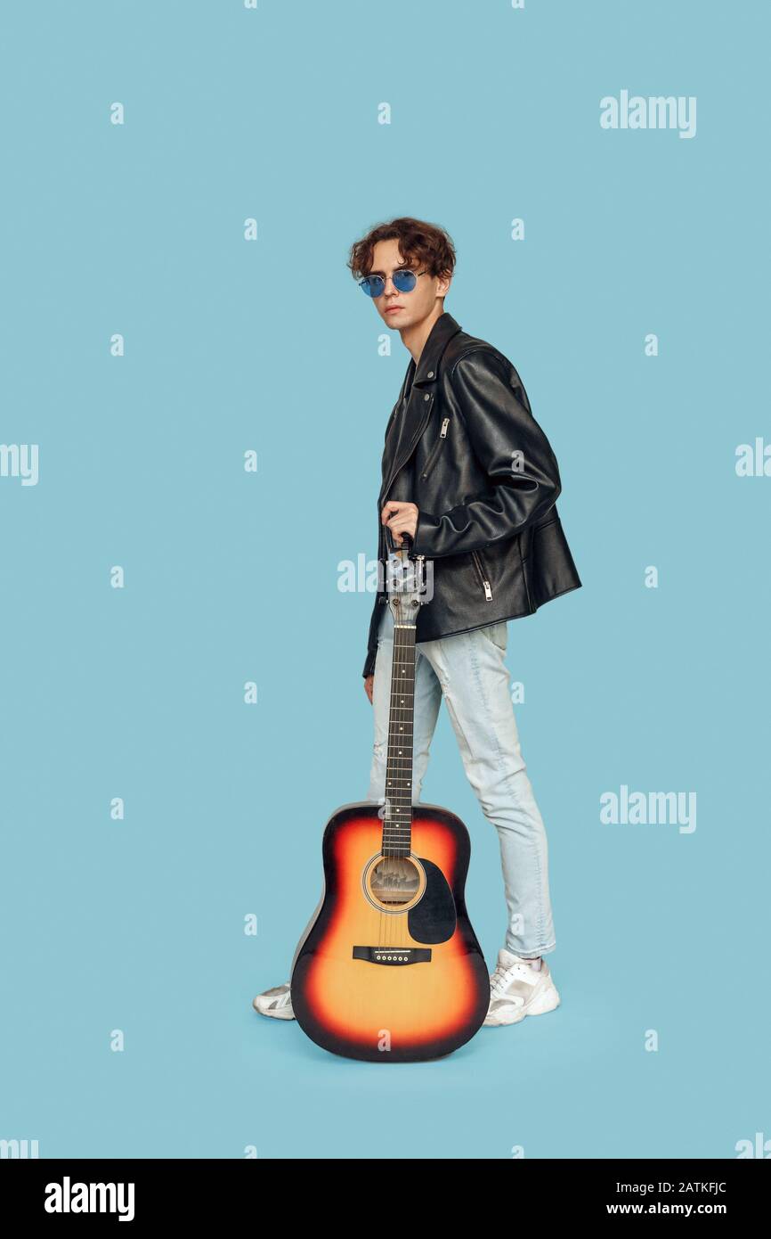 Freestyle. Man in leather jacket and sunglasses standing isolated on ...