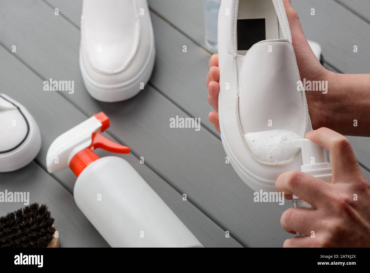 Washing shoe with foam cleaner. White leather footwear and cleaning ...