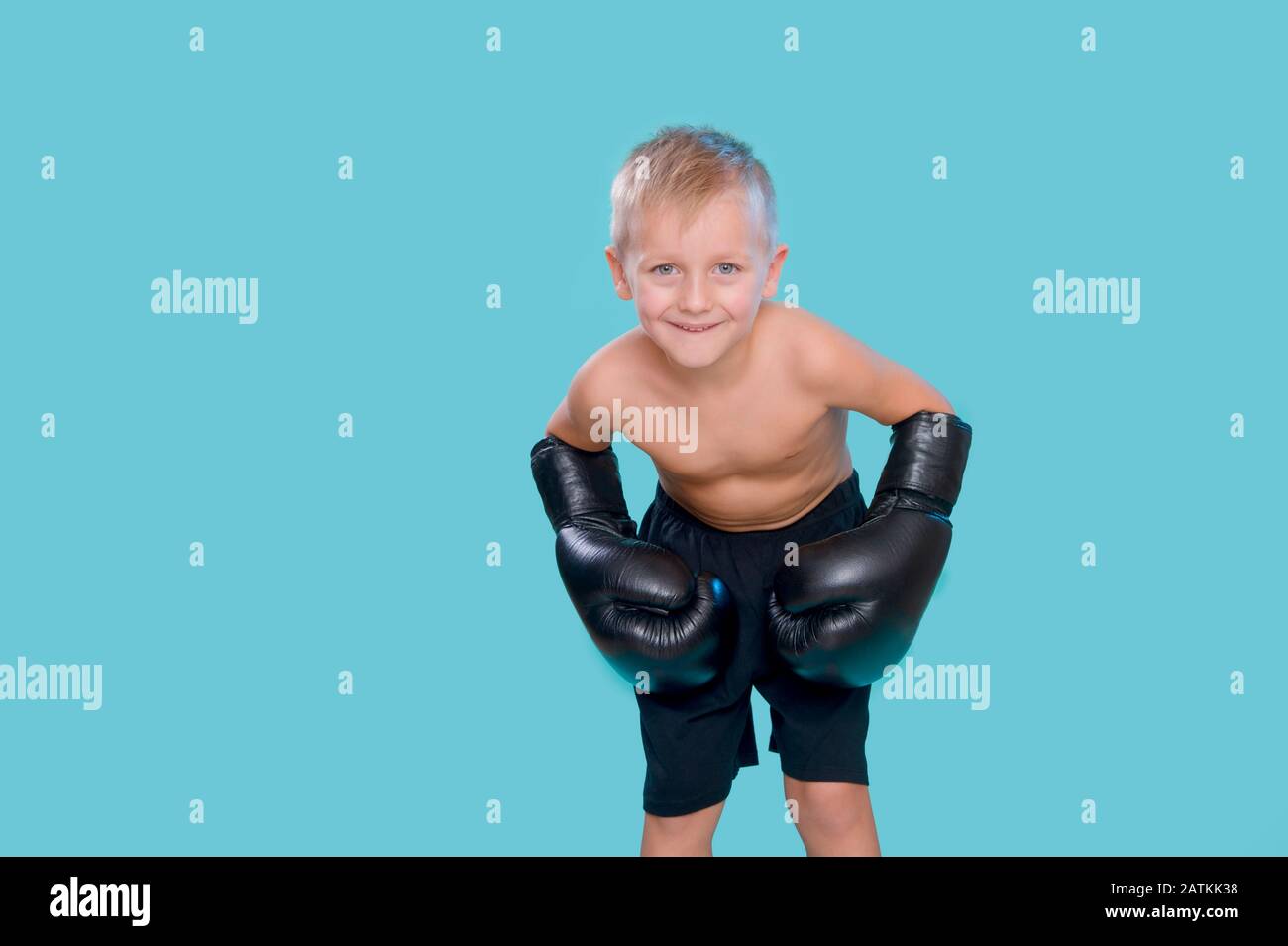 Little kid in the boxing gloves, dreaming about victory, championship ...